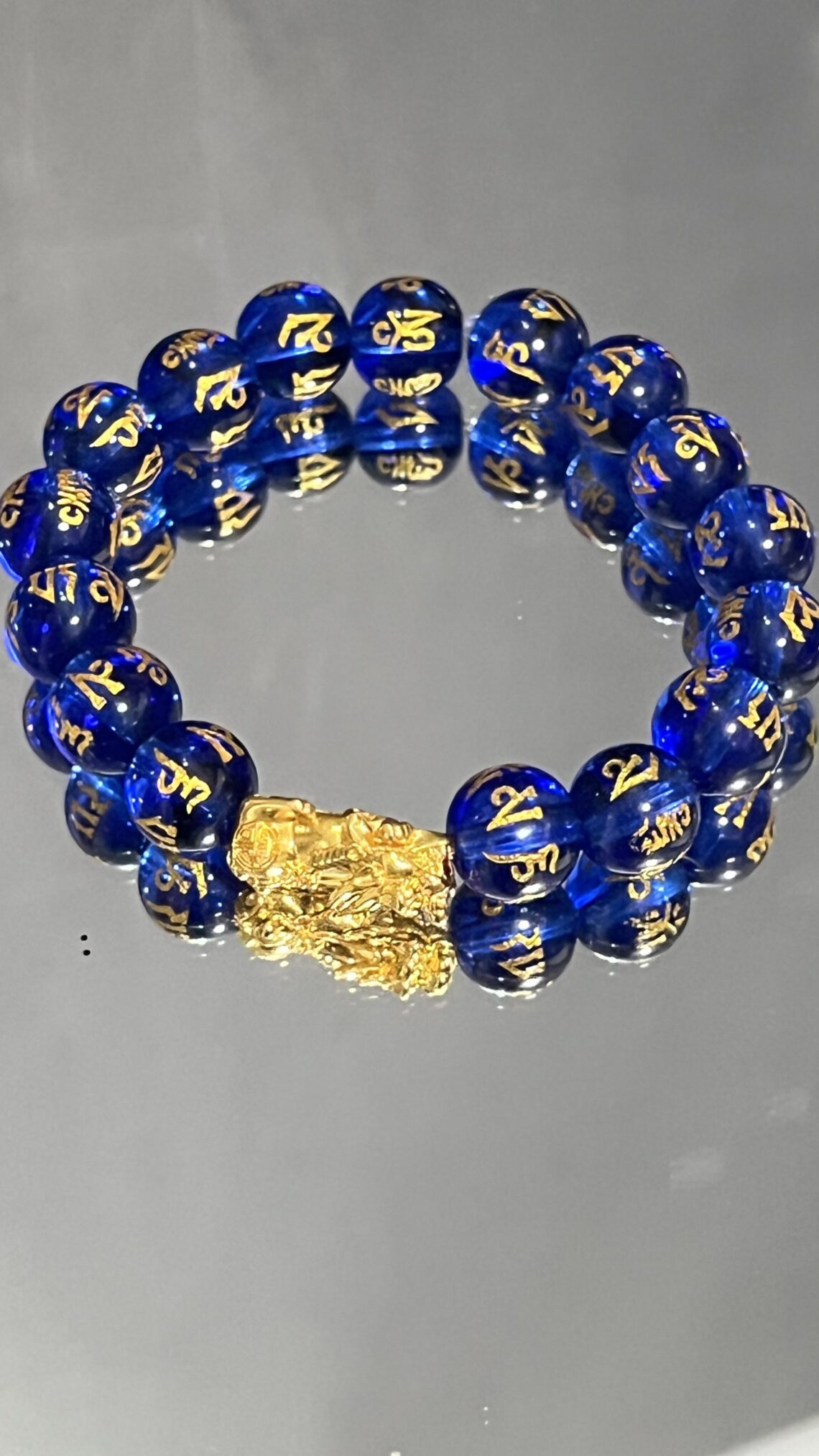 Zabel 18k Gold Medium Pixiu Piyao. Blue Onyx beads with golden mantra ...